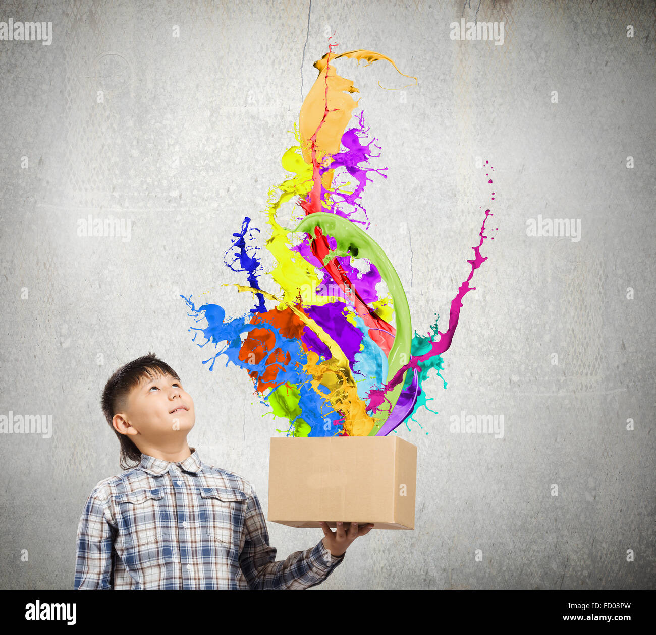 Cute boy splashing colorful paint from carton box Stock Photo - Alamy