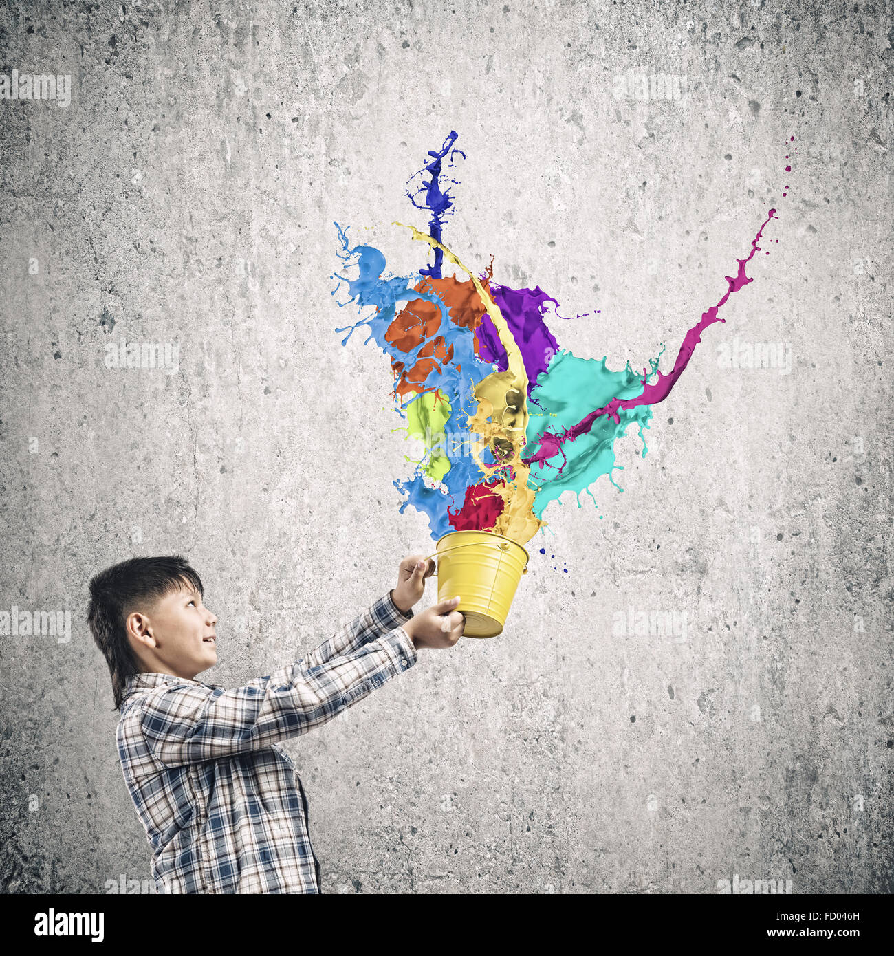 Cute boy splashing colorful paint from bucket Stock Photo - Alamy