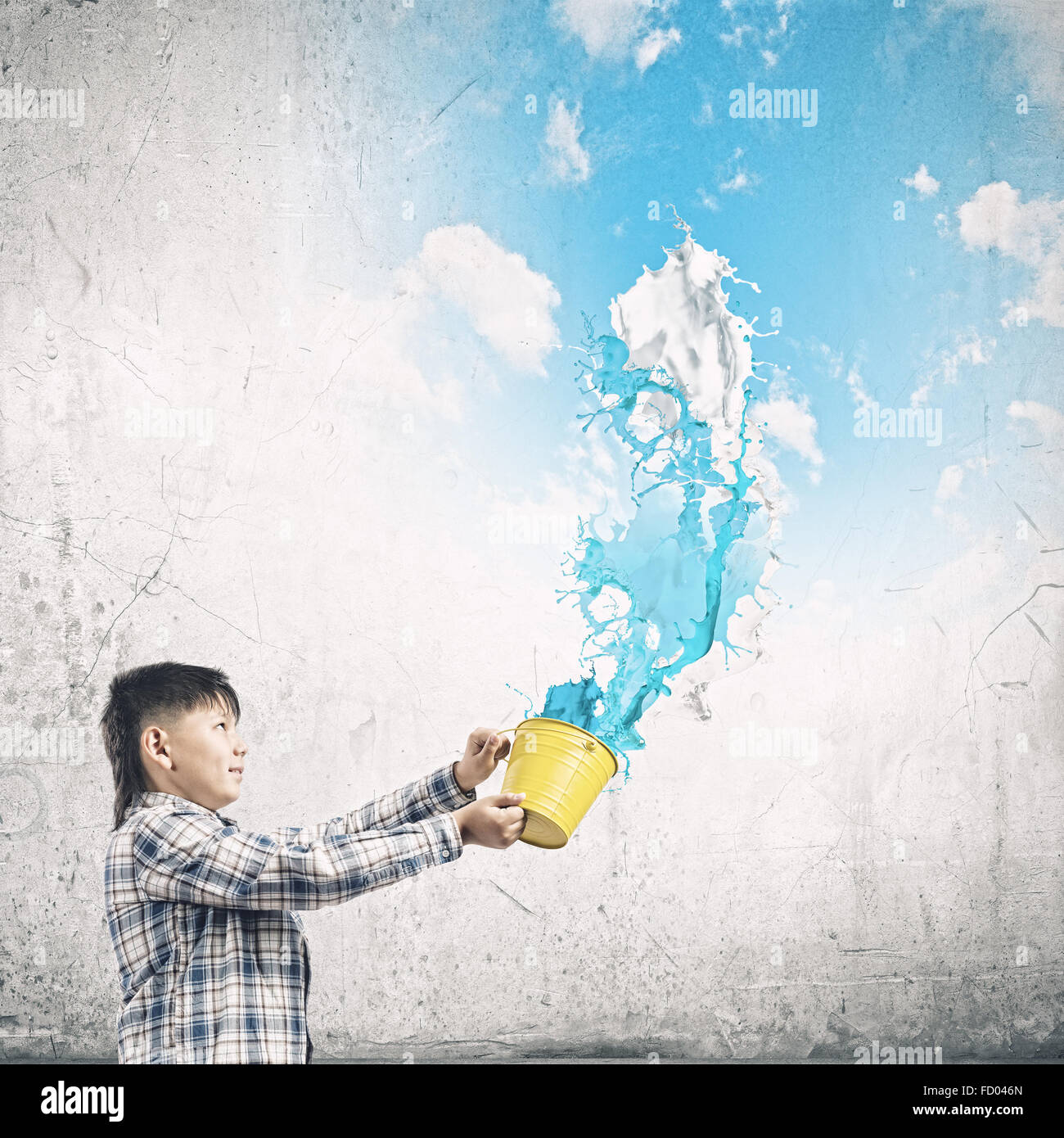 Cute boy splashing colorful paint from bucket Stock Photo - Alamy