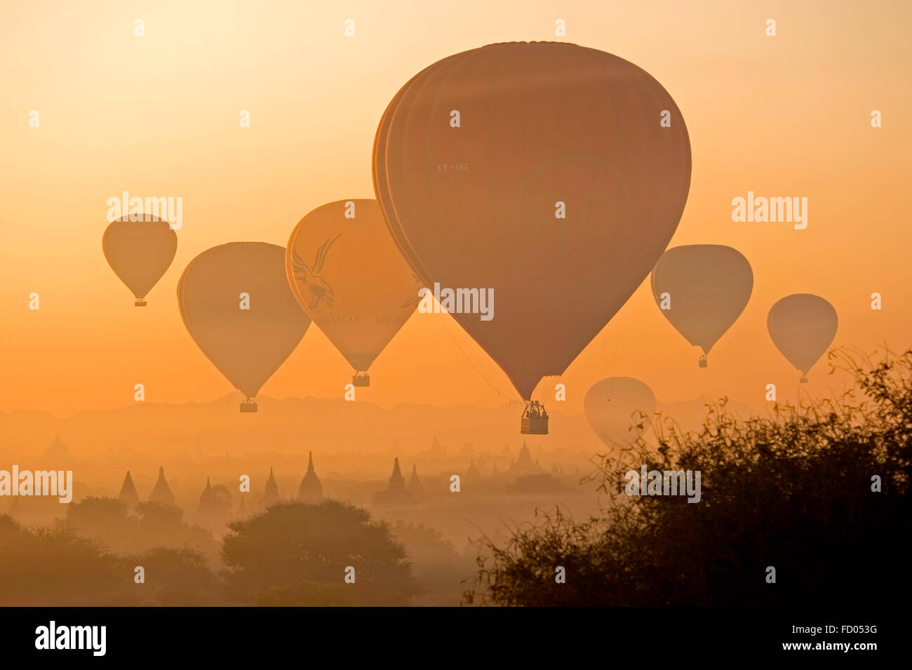 Hot air balloons in the mist at sunrise in Bagan, Myanmar Stock Photo ...