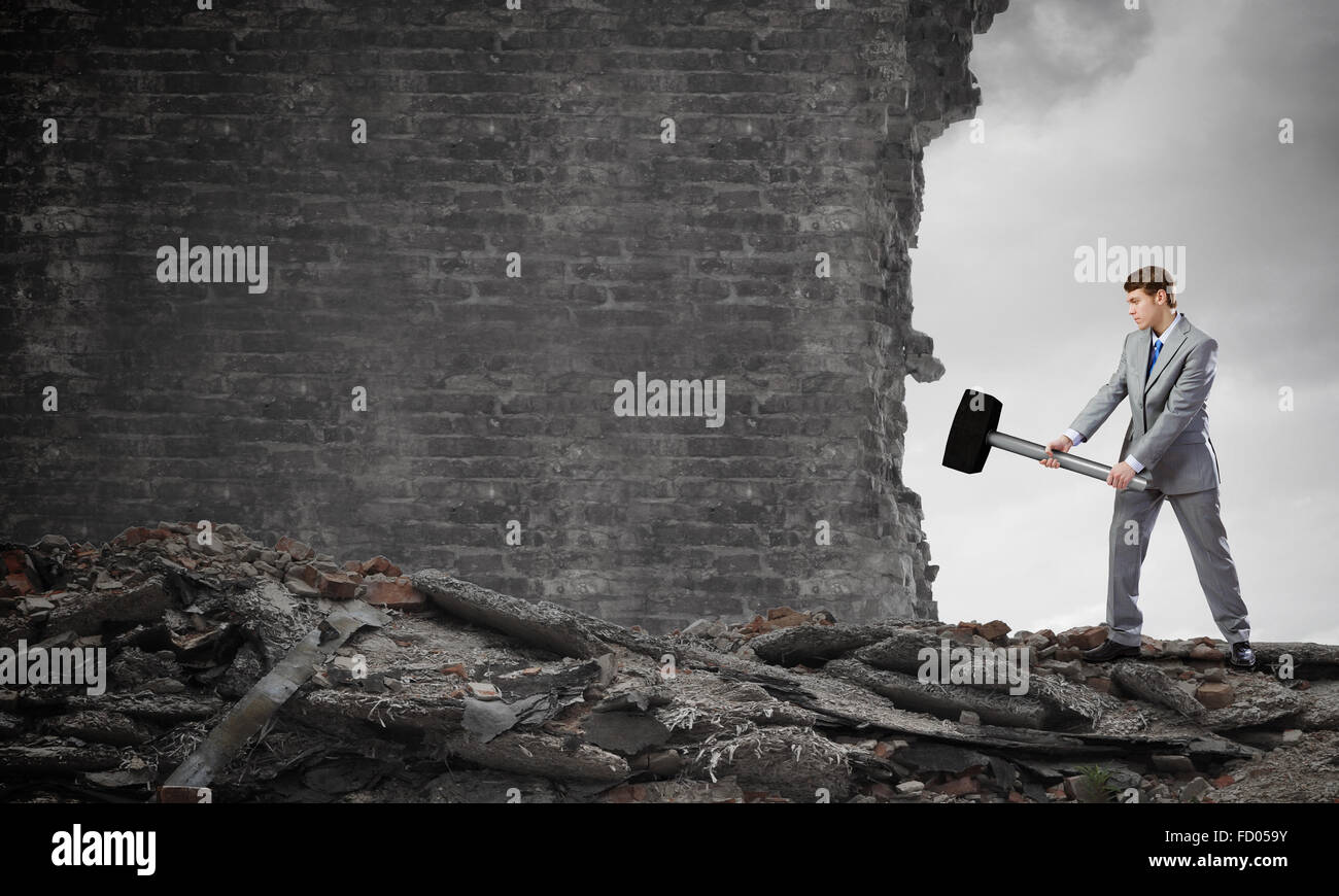 Businessman breaking the wall with hammer hi-res stock photography and ...