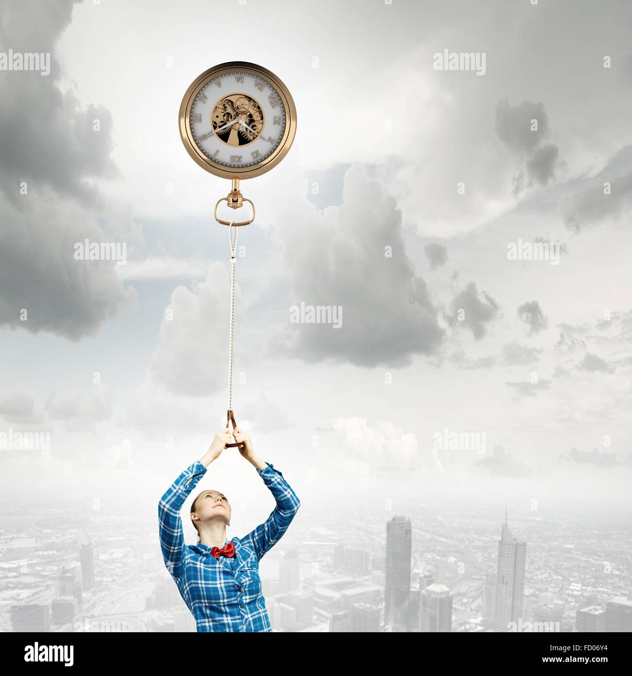 Young woman standing on edge of rock with pocket watch Stock Photo - Alamy
