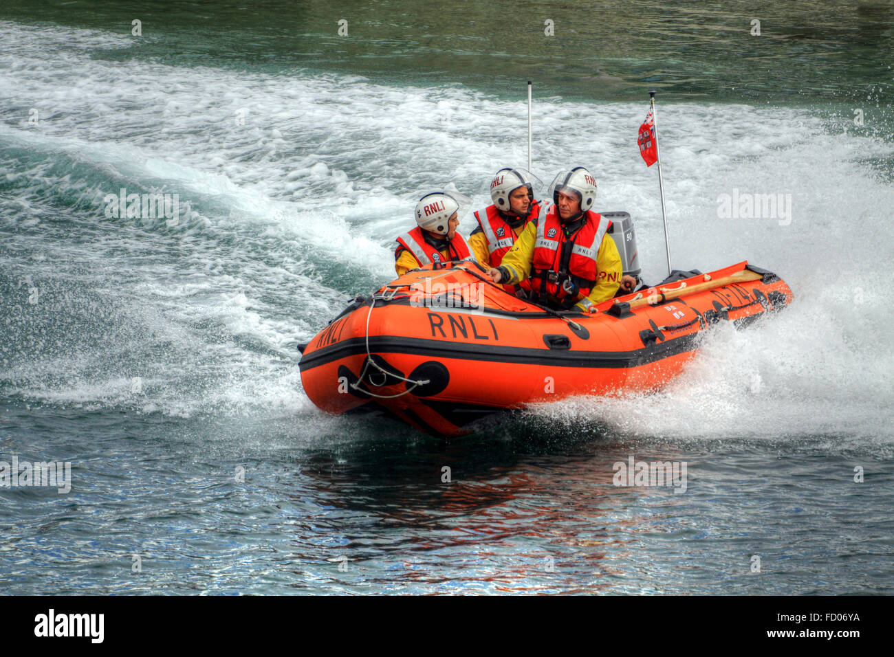 Looe RNLI's D Class inshore lifeboat in Looe river with a crew of 3 ...