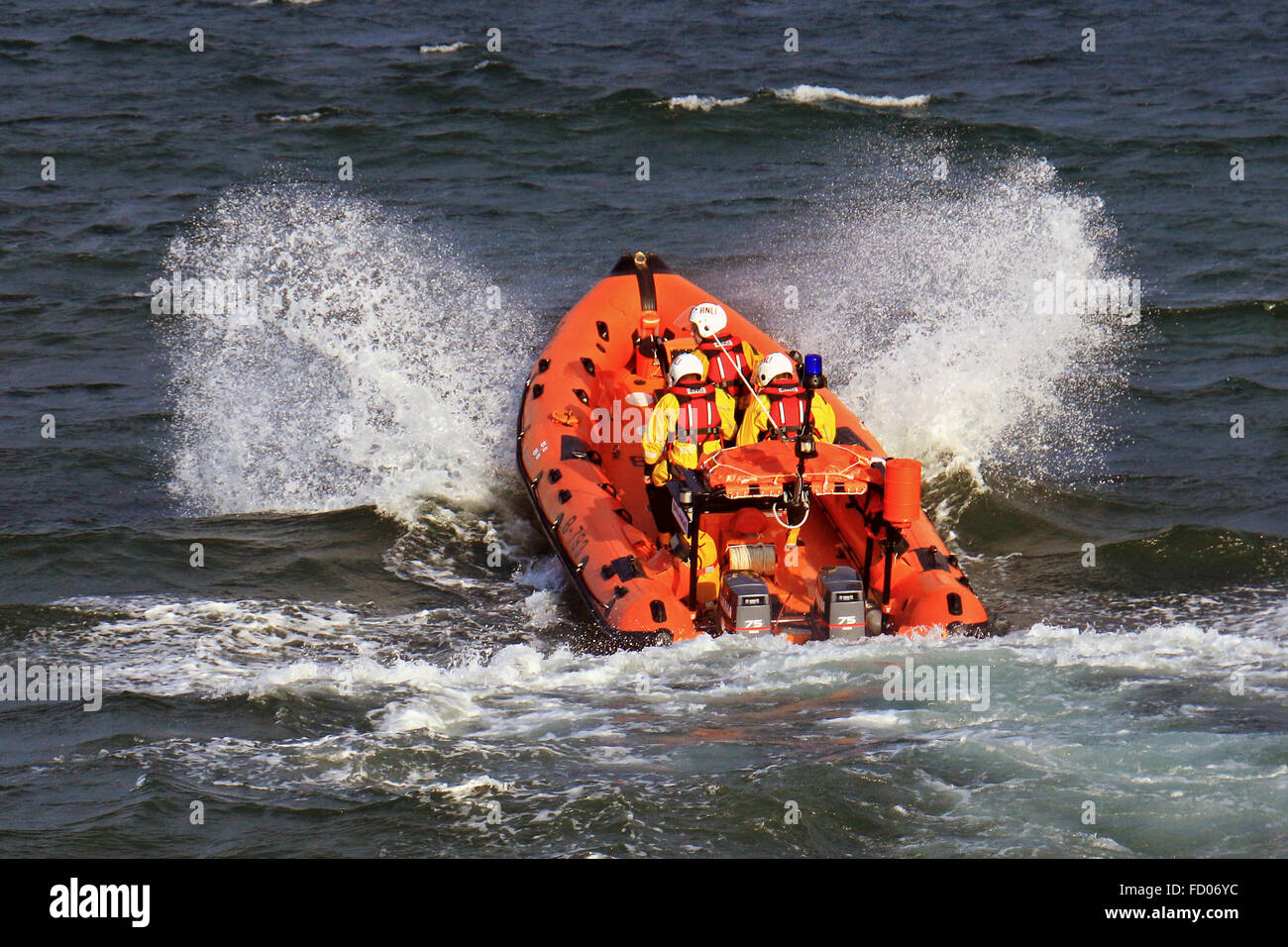Looe RNLI's Atlantic 75 breaks through the surf heading out into Looe ...