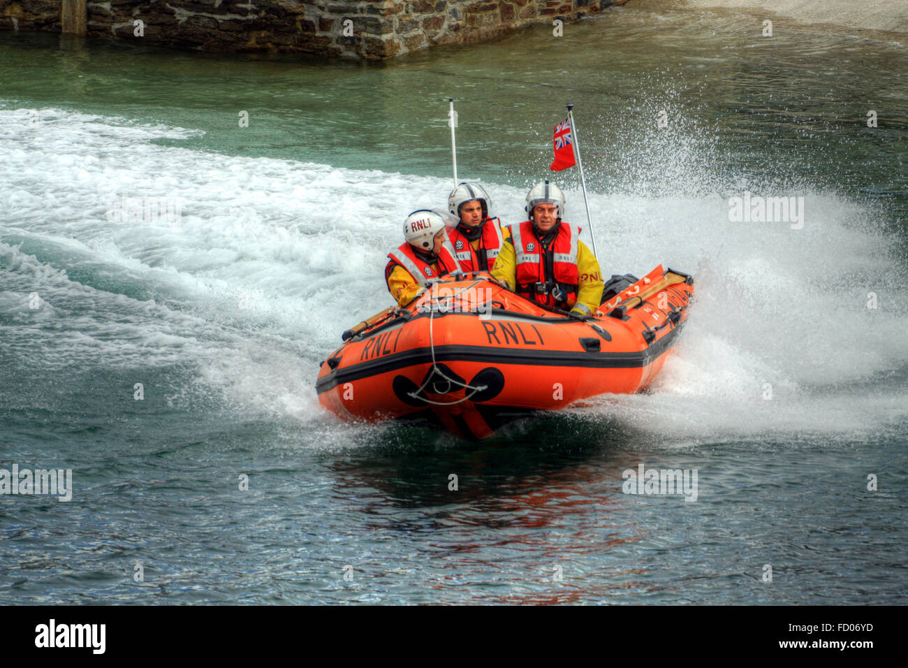 Looe RNLI's D Class inshore lifeboat in Looe river with a crew of 3 ...