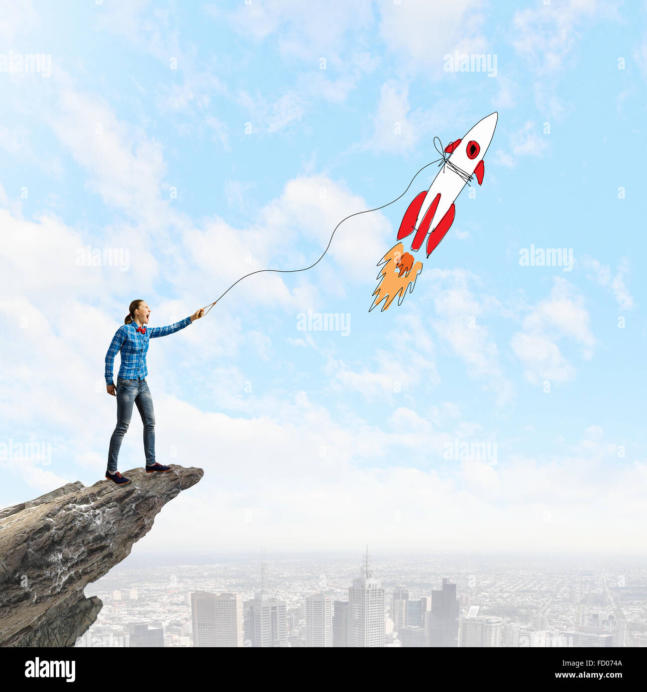 Young woman catching rocket flying in sky with rope Stock Photo - Alamy