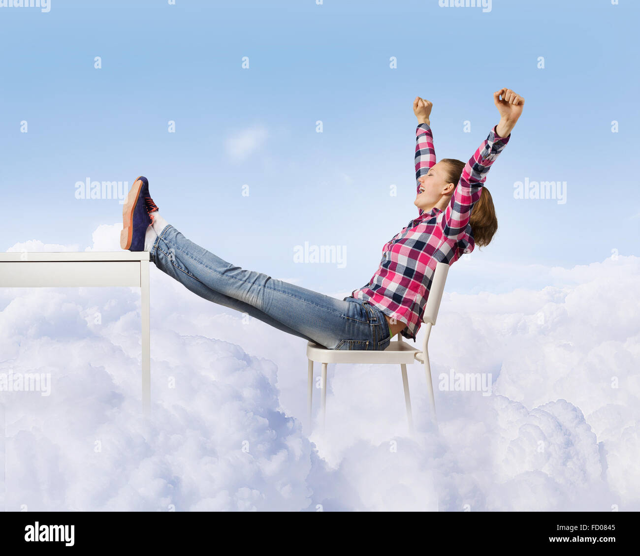 Young woman in casual with arms up celebrating success Stock Photo - Alamy