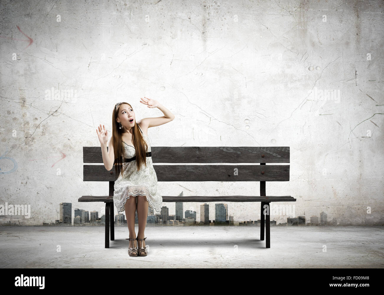 Young pretty scared asian woman sitting on bench Stock Photo - Alamy