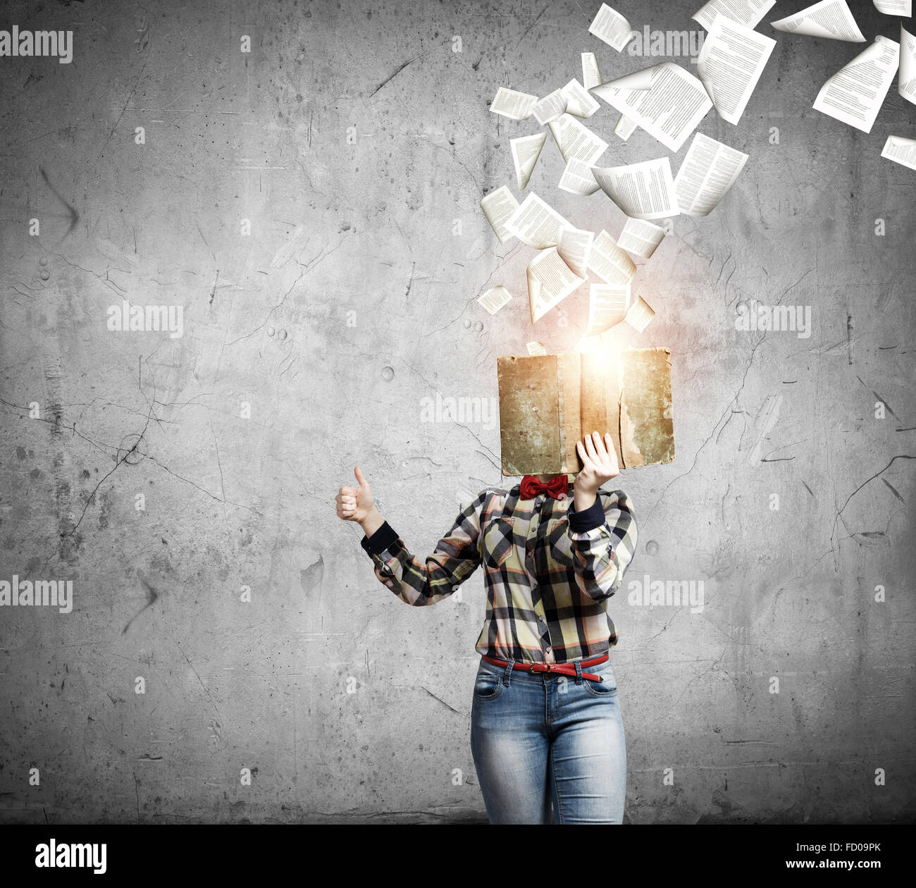 Woman in casual wear hiding her face behind book Stock Photo - Alamy