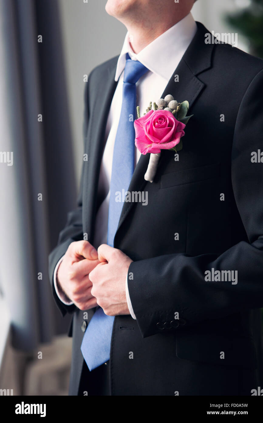 the groom's buttonhole in the form of a bright pink rose Stock Photo ...