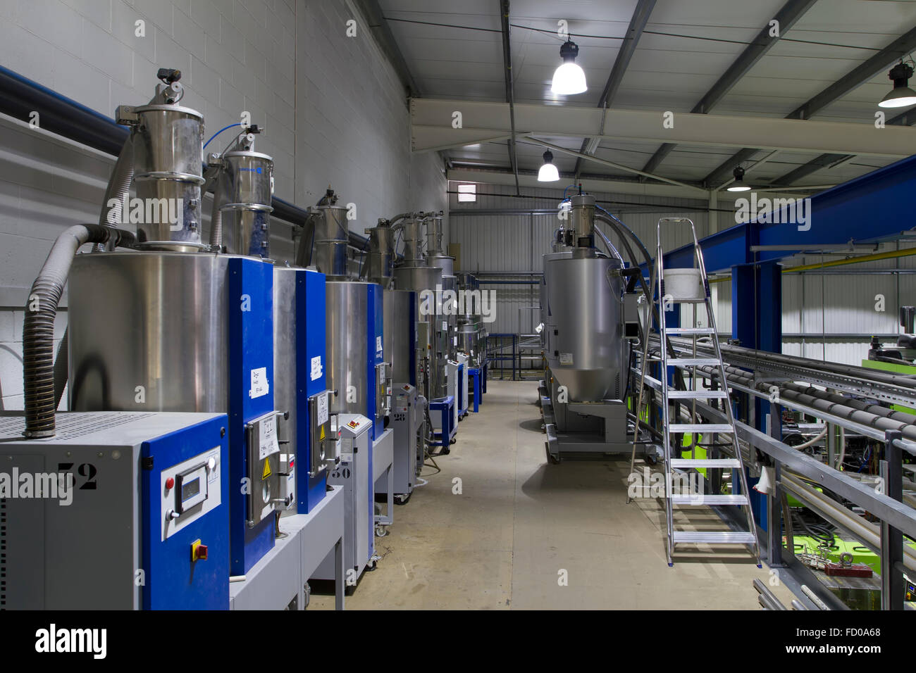 Injection moulding material feed system driers Stock Photo - Alamy
