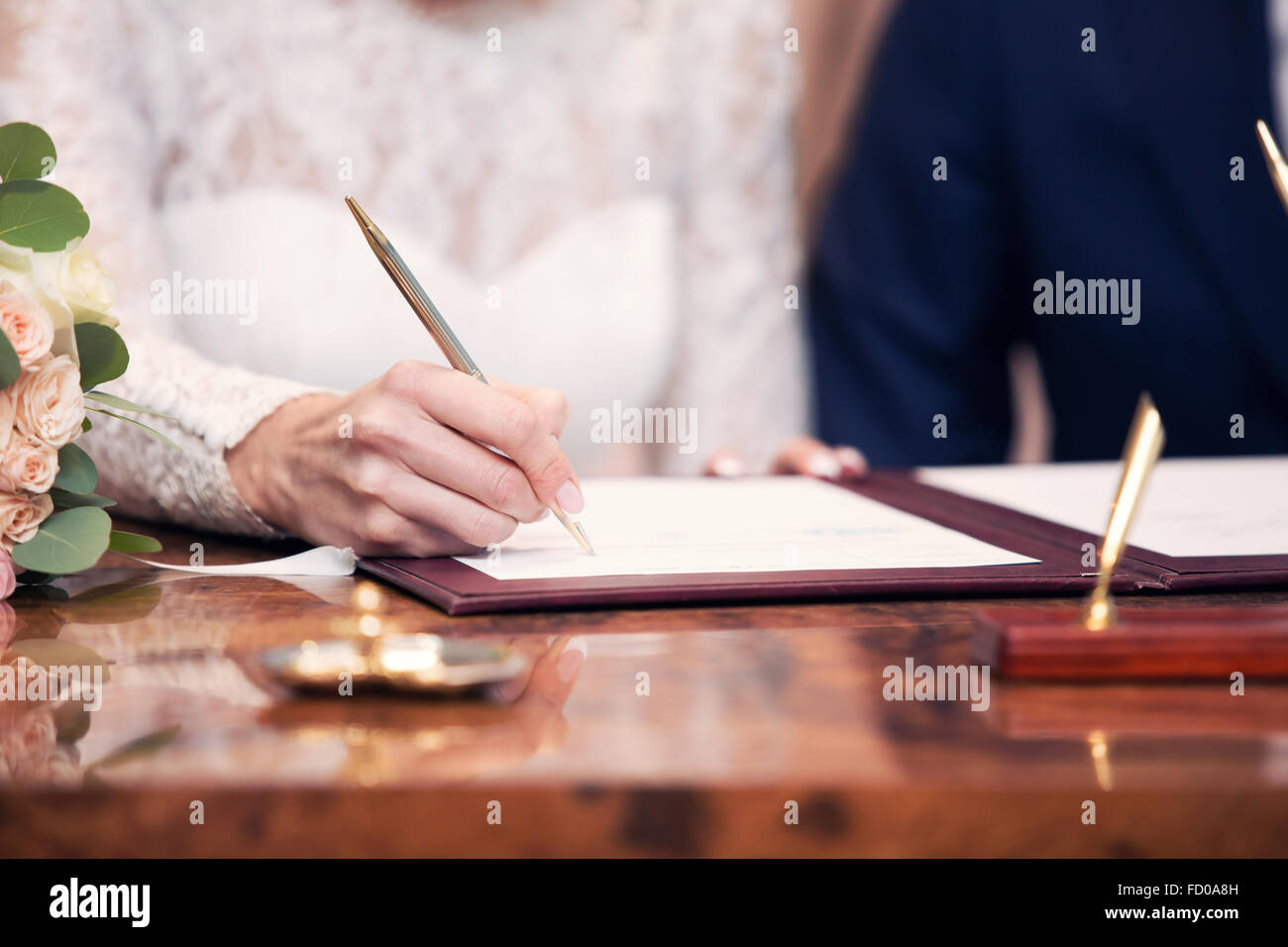 newlyweds append signatures in a registry office during wedding ...