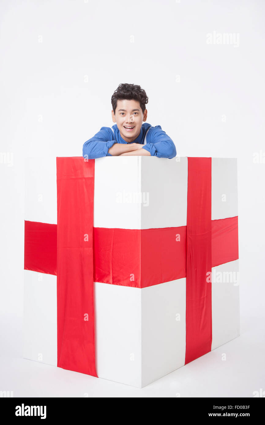 Man in blue shirt placed in a gift box staring forward Stock Photo - Alamy