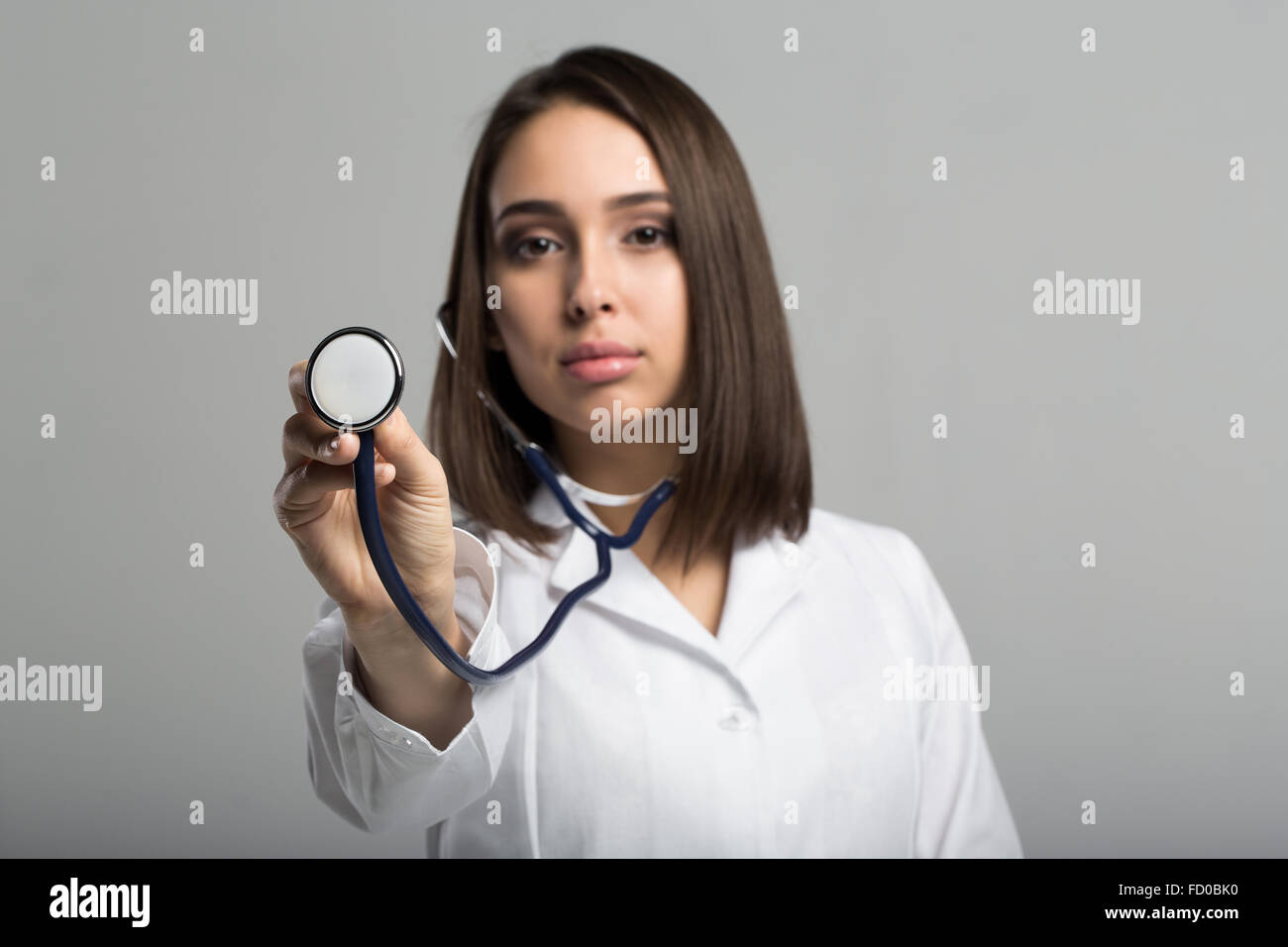woman doctor in a dressing gown on a gray background Stock Photo - Alamy