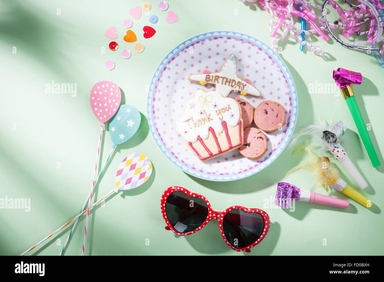 High angle of different shapes of cookies on plate with party related ...