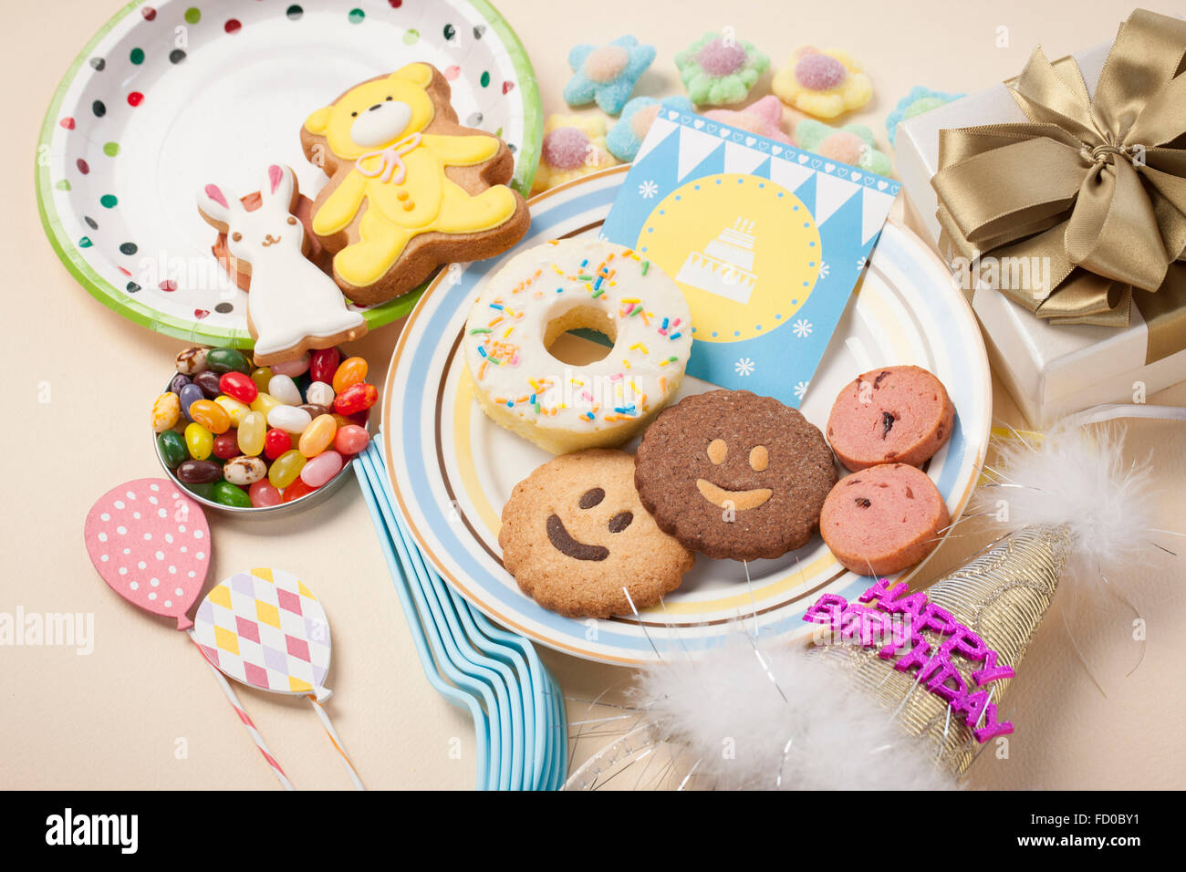 High angle of different types of cookies on plate with birthday party ...