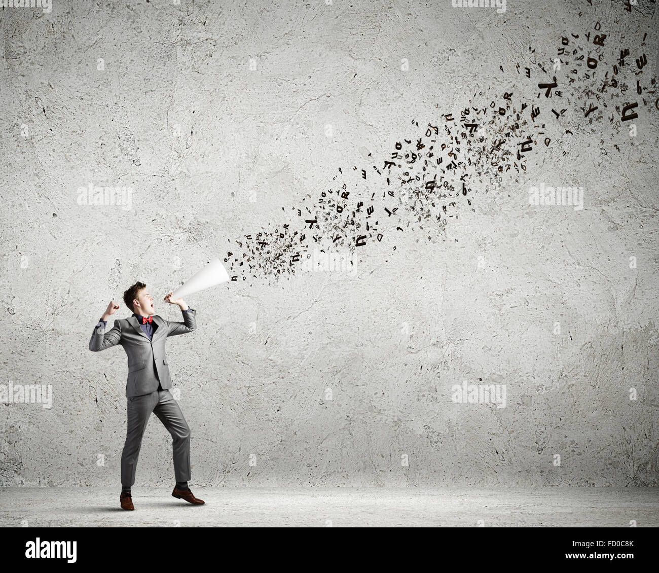 Young excited businessman screaming in paper trumpet Stock Photo - Alamy