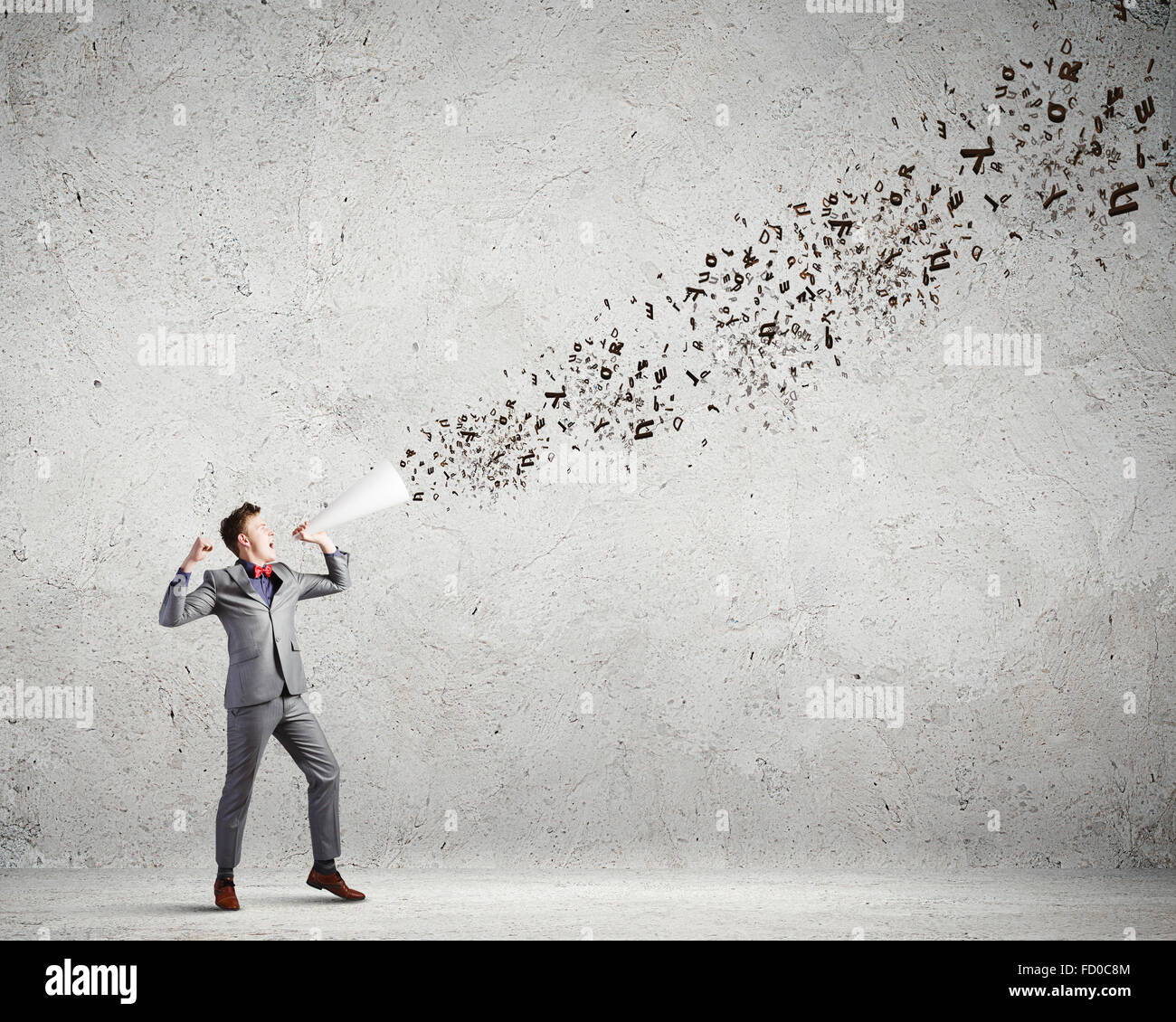 Young excited businessman screaming in paper trumpet Stock Photo - Alamy