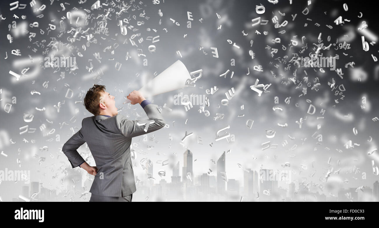 Young excited businessman screaming in paper trumpet Stock Photo - Alamy