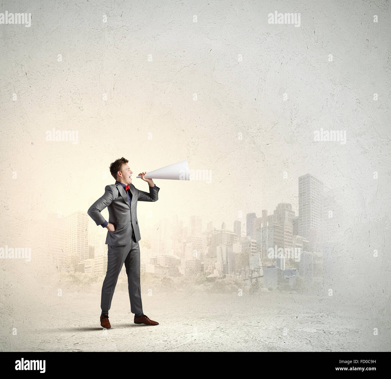 Young excited businessman screaming in paper trumpet Stock Photo - Alamy