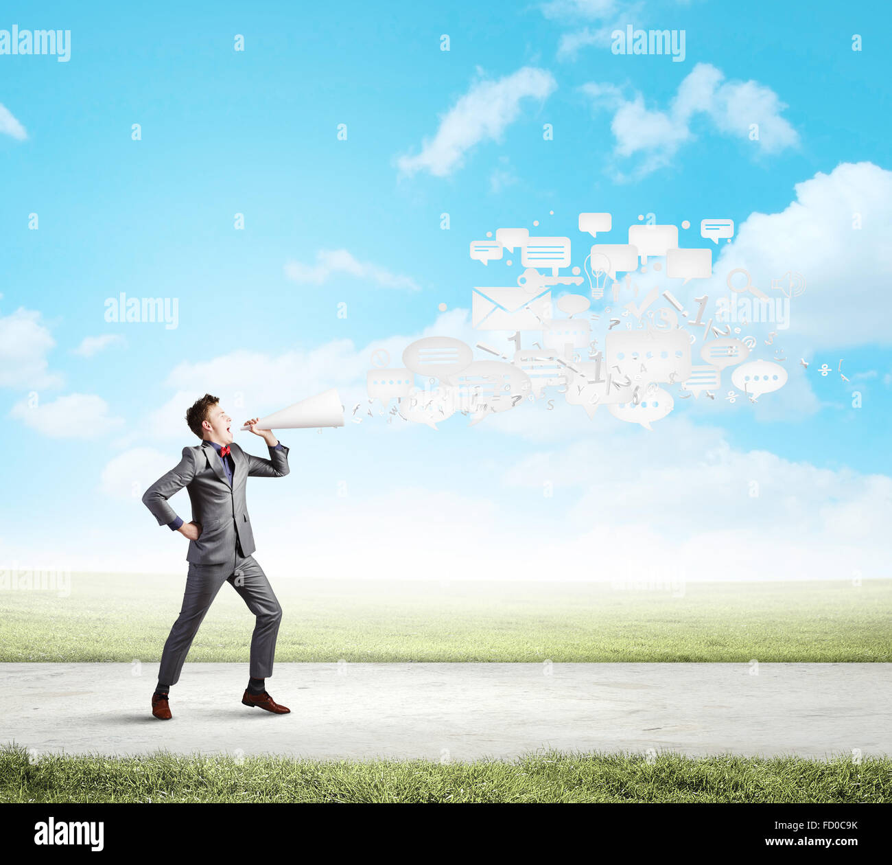 Young excited businessman screaming in paper trumpet Stock Photo - Alamy