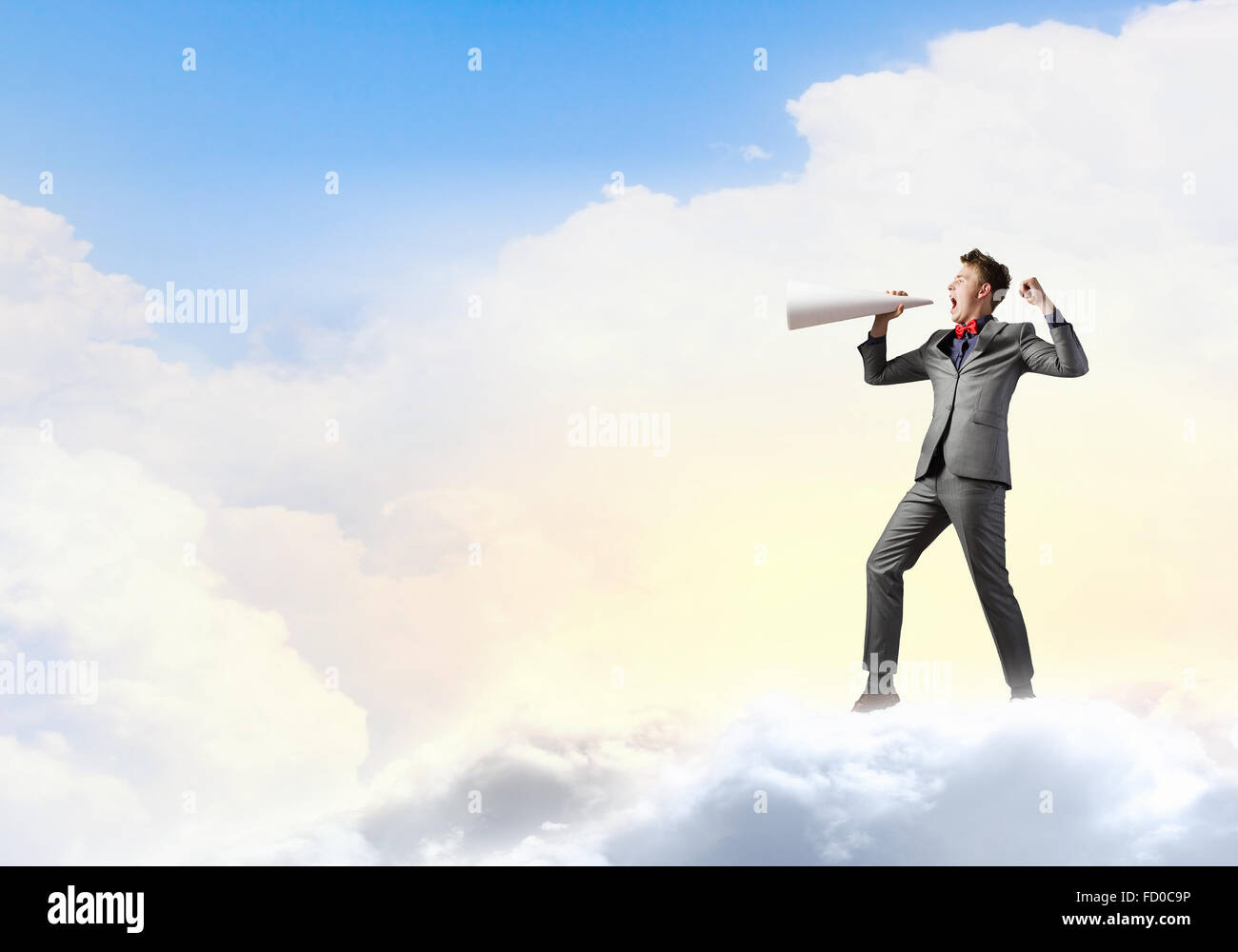 Young excited businessman screaming in paper trumpet Stock Photo - Alamy