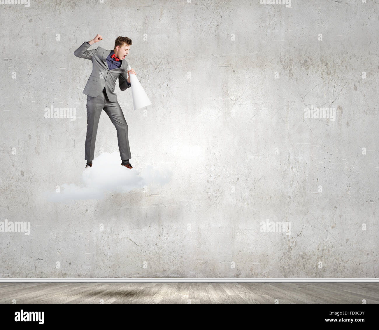 Young excited businessman screaming in paper trumpet Stock Photo - Alamy