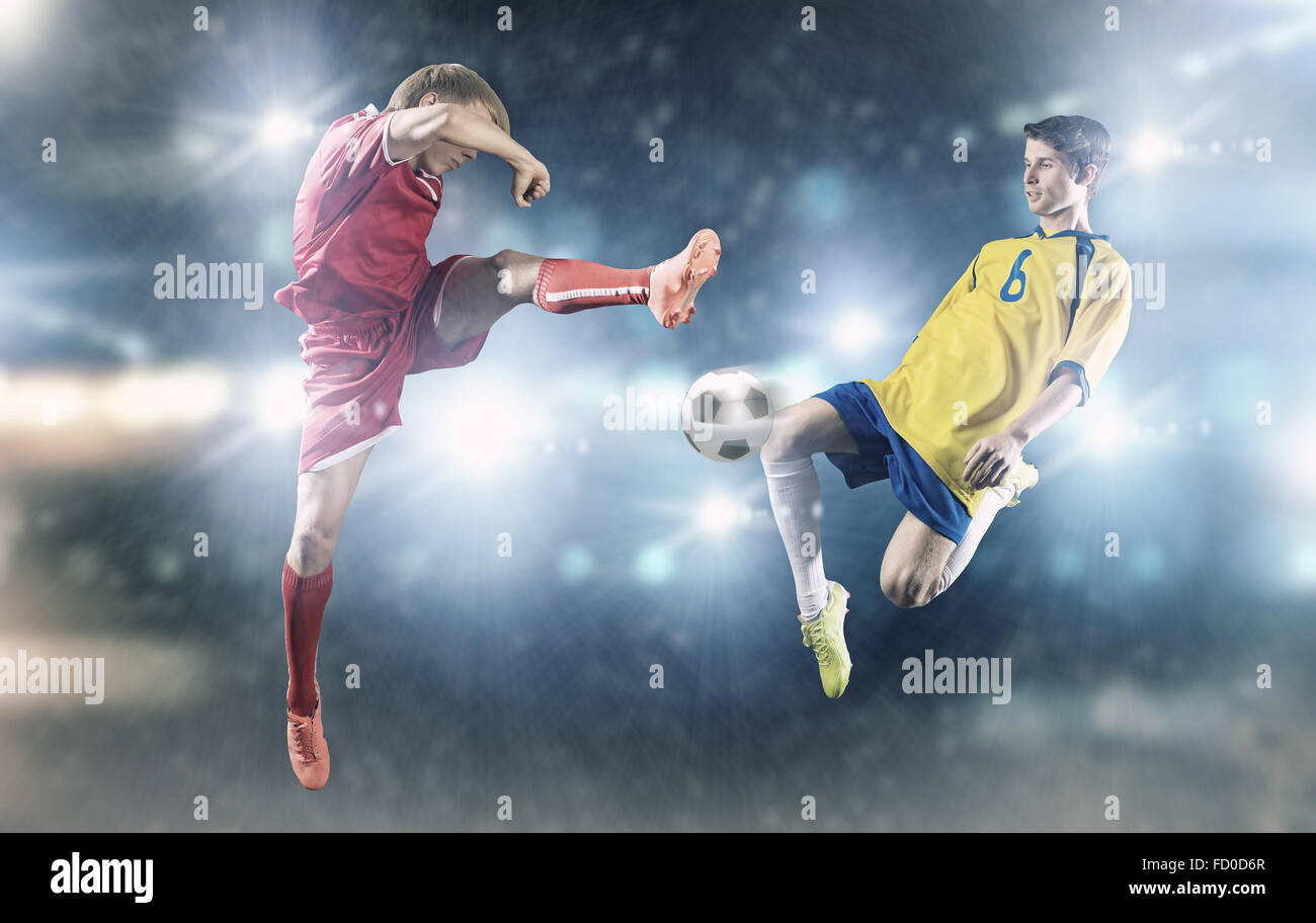 Two young football players struggling for ball Stock Photo - Alamy