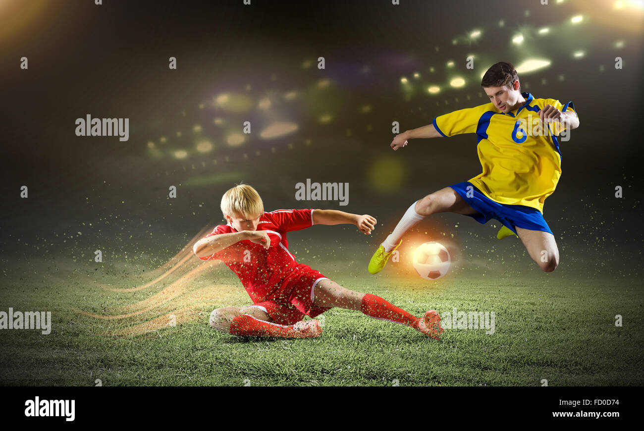 Two young football players struggling for ball Stock Photo - Alamy