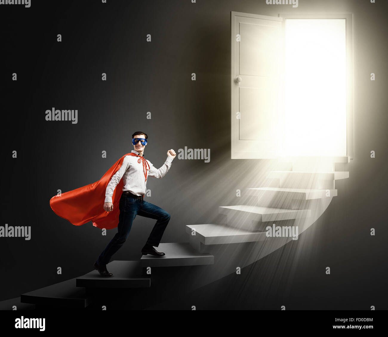 Young confident superman in mask and cape walking on ladder Stock Photo ...