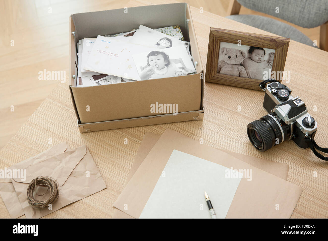 High angle of a a box of old photos, photo frame, and a camera Stock ...