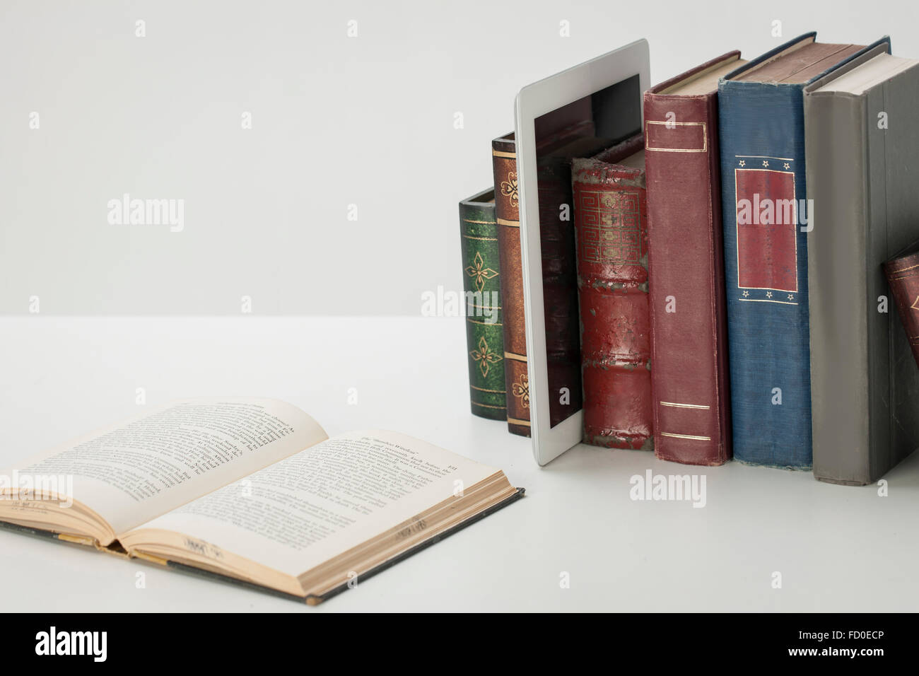 Old book open and other books arranged on the desk Stock Photo - Alamy