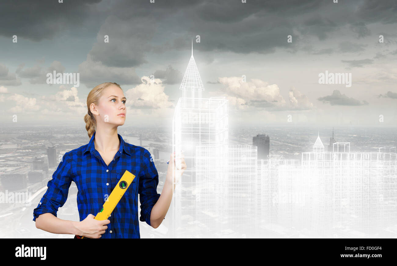 Young pretty woman engineer with tool belt on waist Stock Photo - Alamy