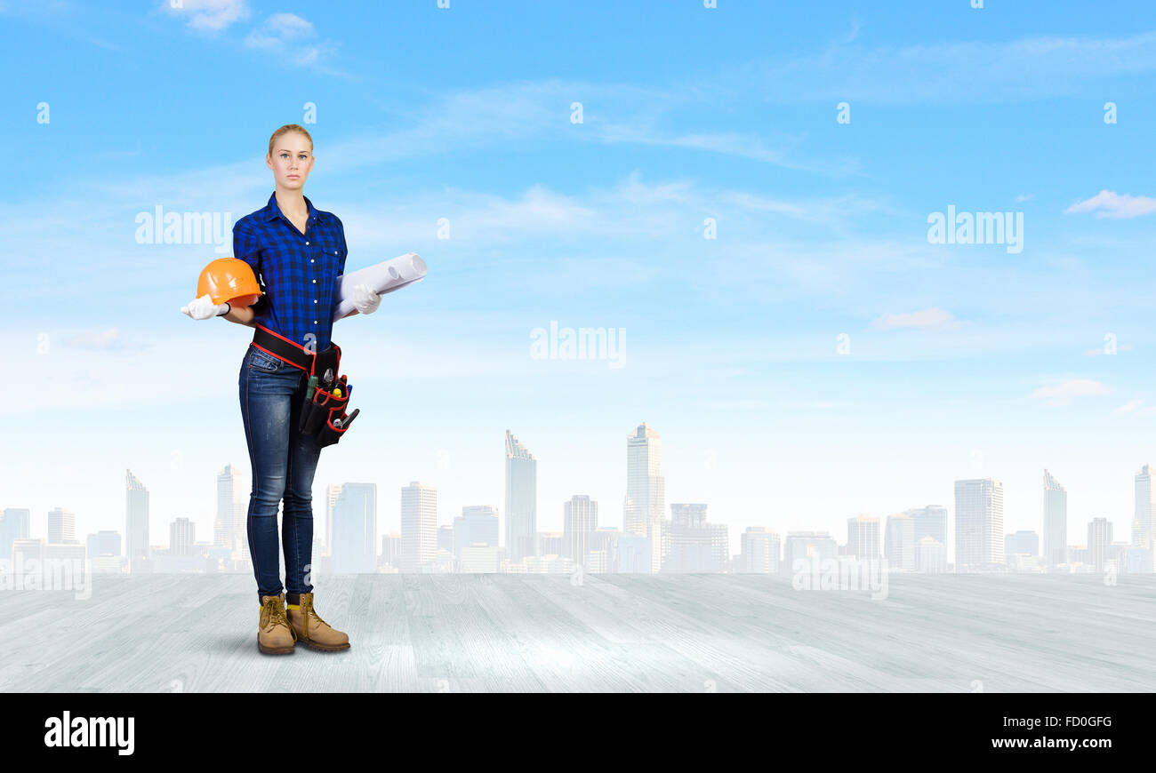 Young pretty woman engineer with tool belt on waist Stock Photo - Alamy