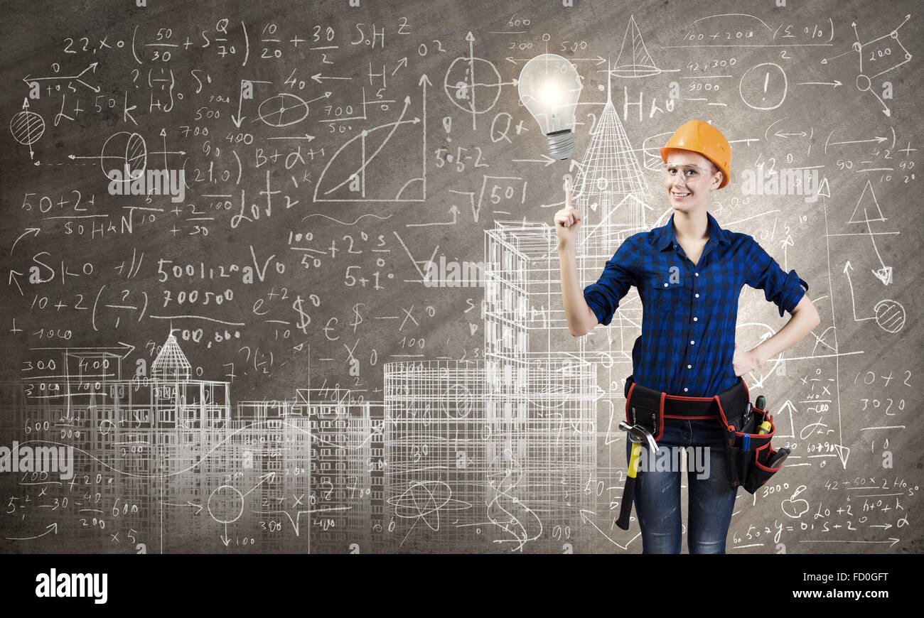 Young pretty woman engineer with tool belt on waist Stock Photo - Alamy