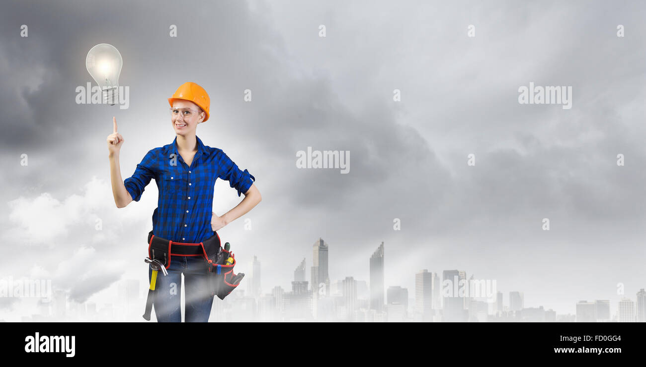 Young pretty woman engineer with tool belt on waist Stock Photo - Alamy