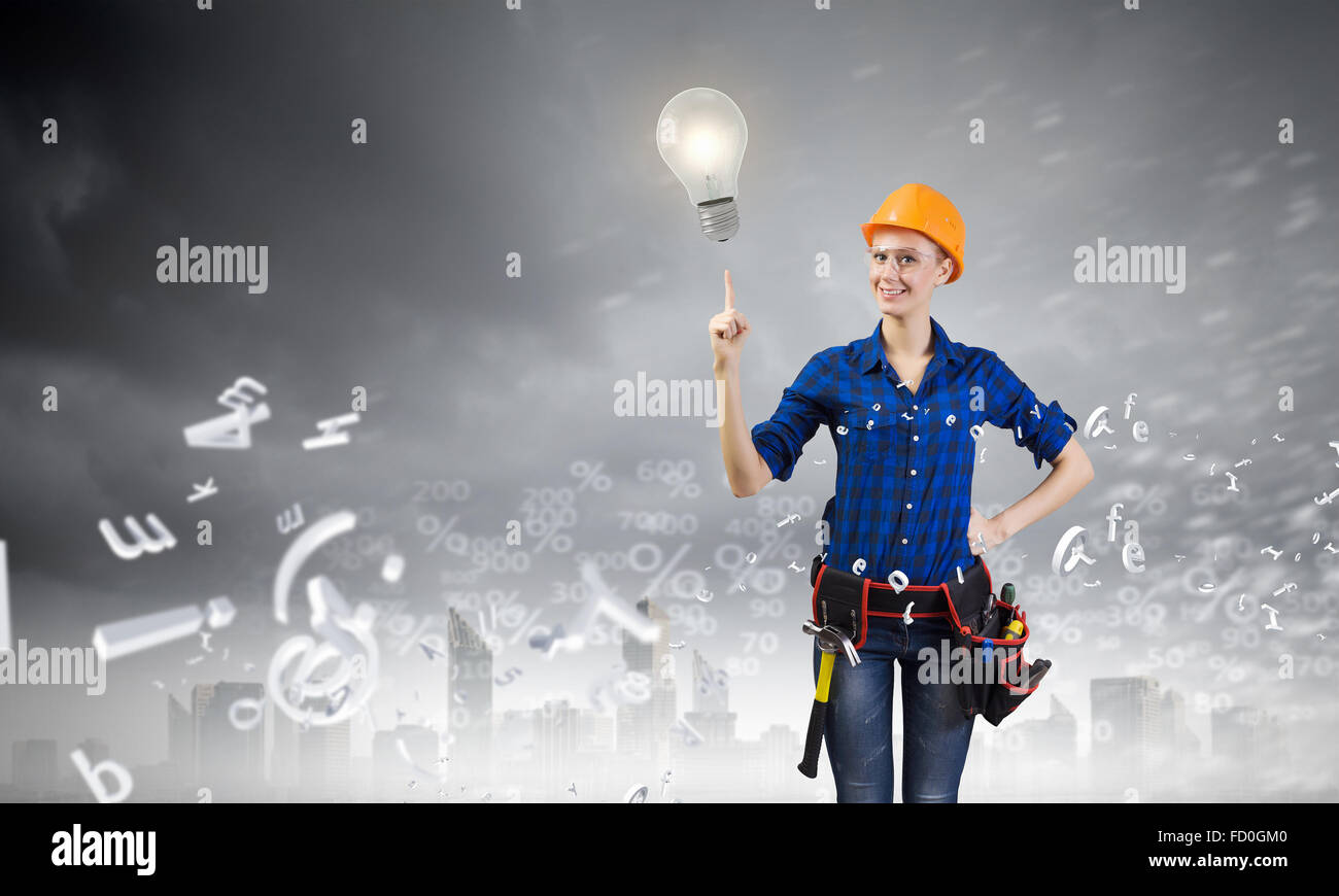 Young pretty woman engineer with tool belt on waist Stock Photo - Alamy