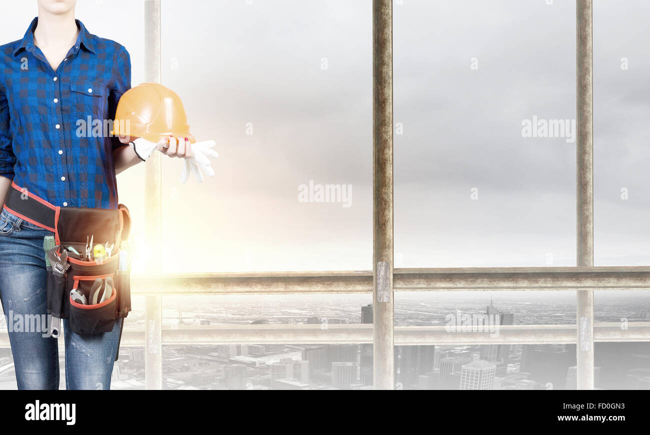 Bottom view of woman engineer with tool belt on waist Stock Photo - Alamy