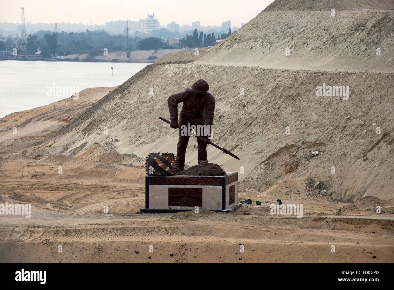 Statue of an Egyptian labourer at work digging in the sand in the Suez ...