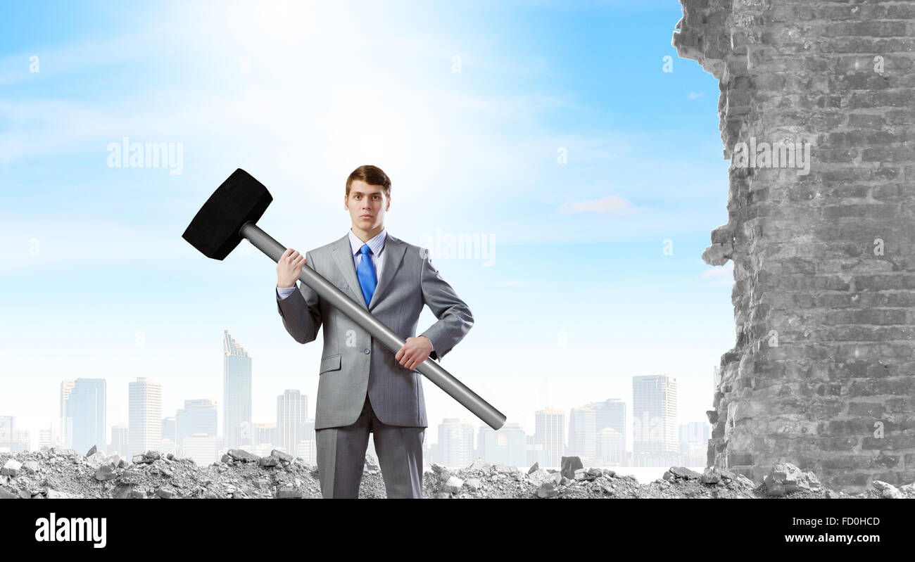 Young determined businessman with big hammer in hands Stock Photo - Alamy