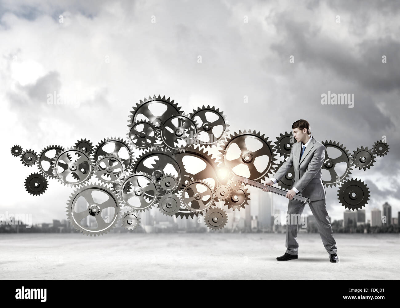 Young determined businessman with wrench fixing mechanism Stock Photo ...