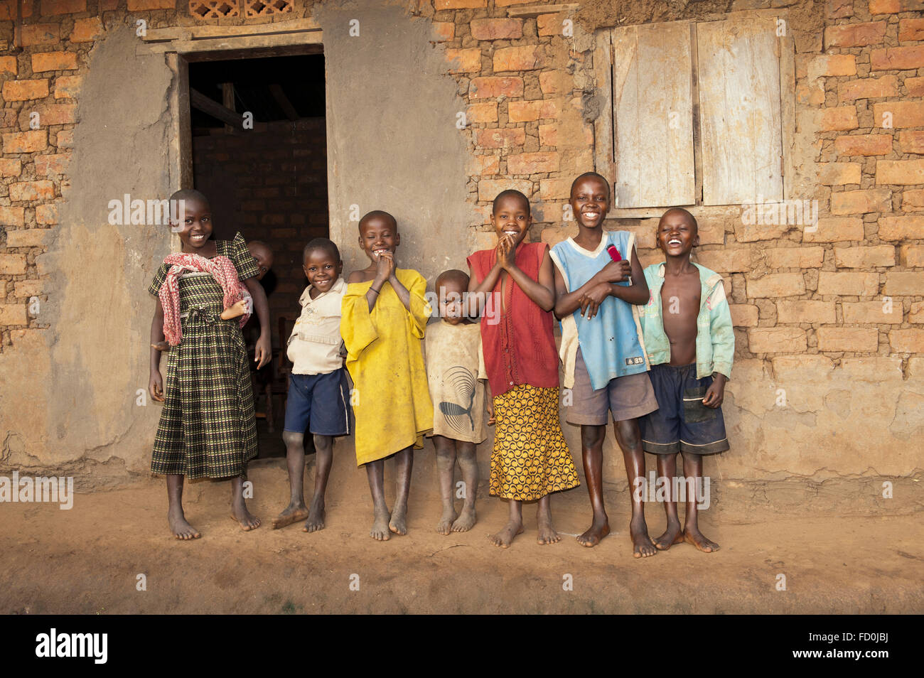 Happy smiling Ugandan children outside their home. Uganda Stock Photo ...