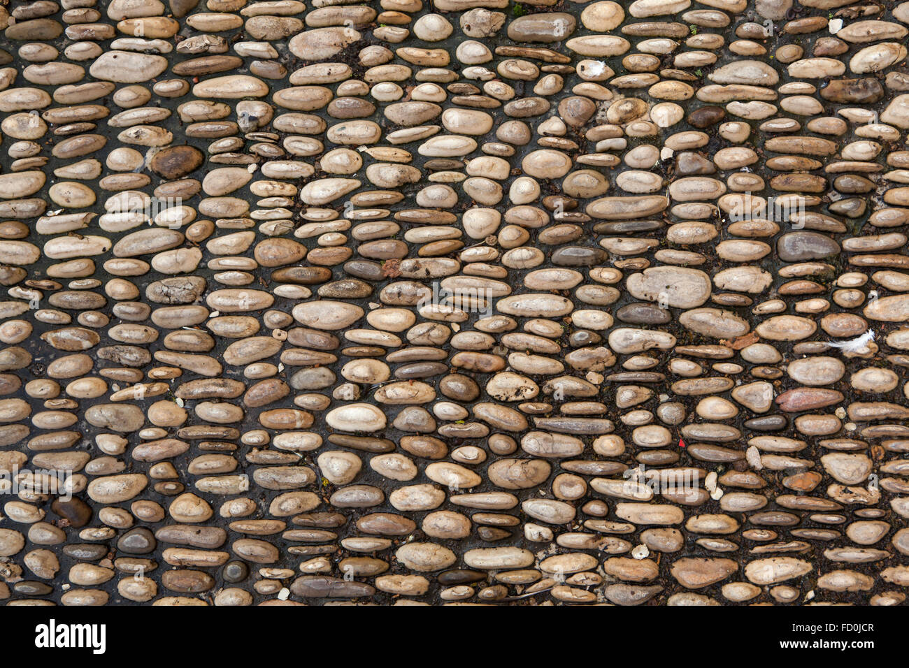 Cobbled pavement made of river rounded pebbles in Cordoba, Andalusia ...