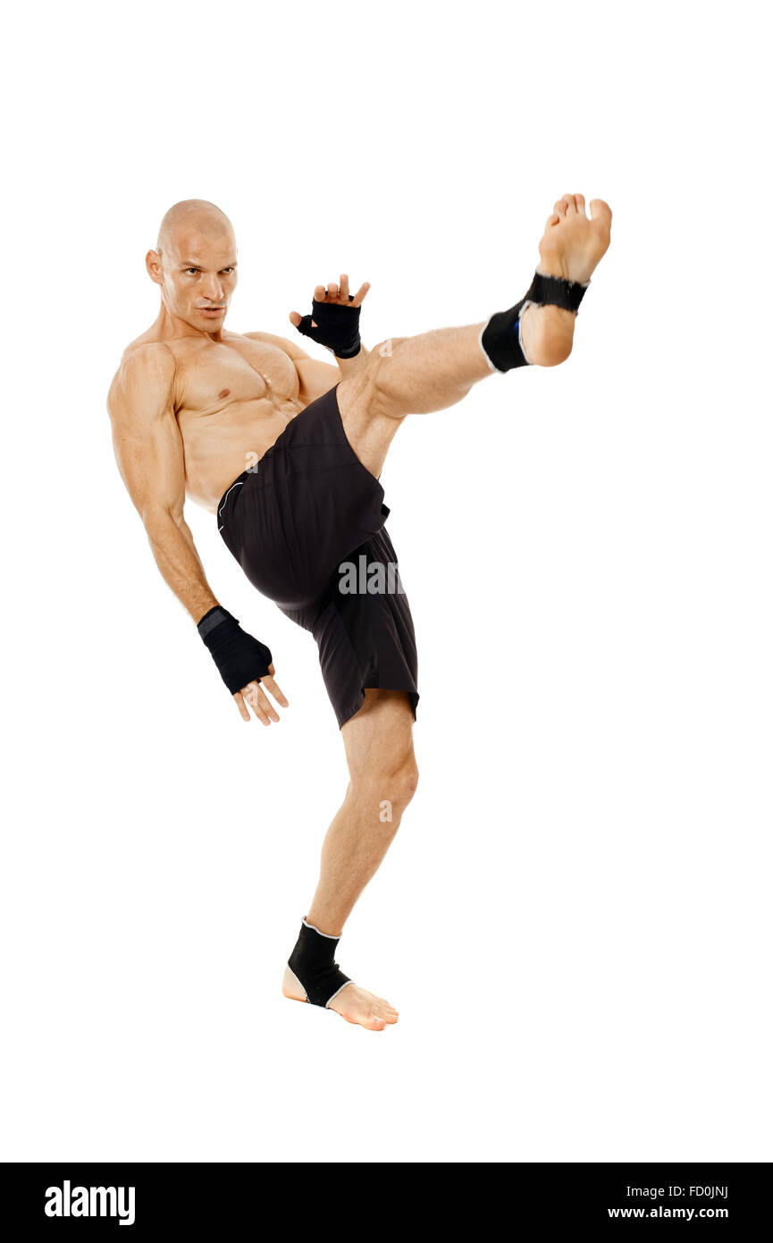 Kickbox fighter executing a strong kick isolated on white Stock Photo ...