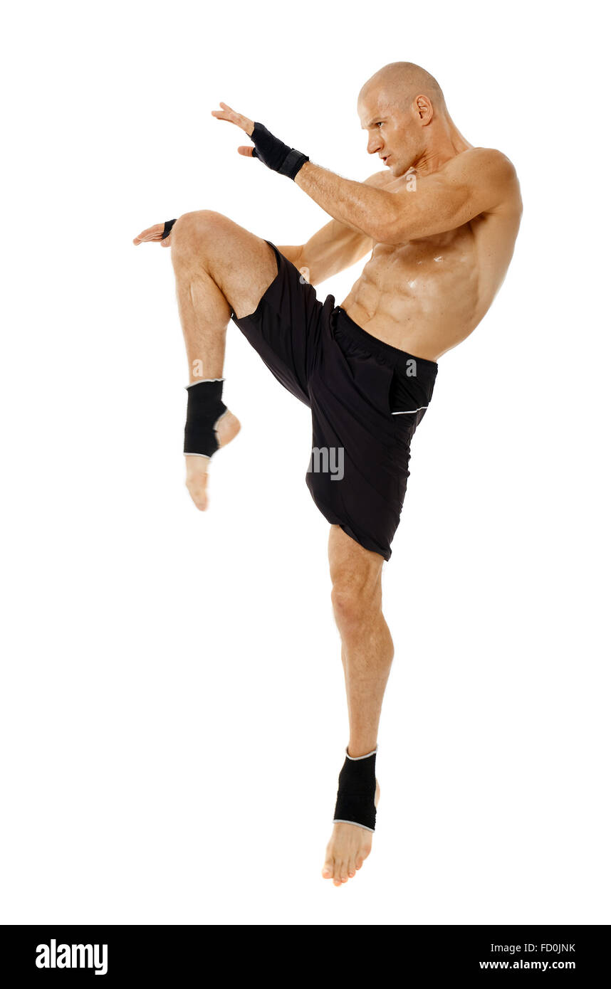 Kickbox fighter executing a strong kick isolated on white Stock Photo ...