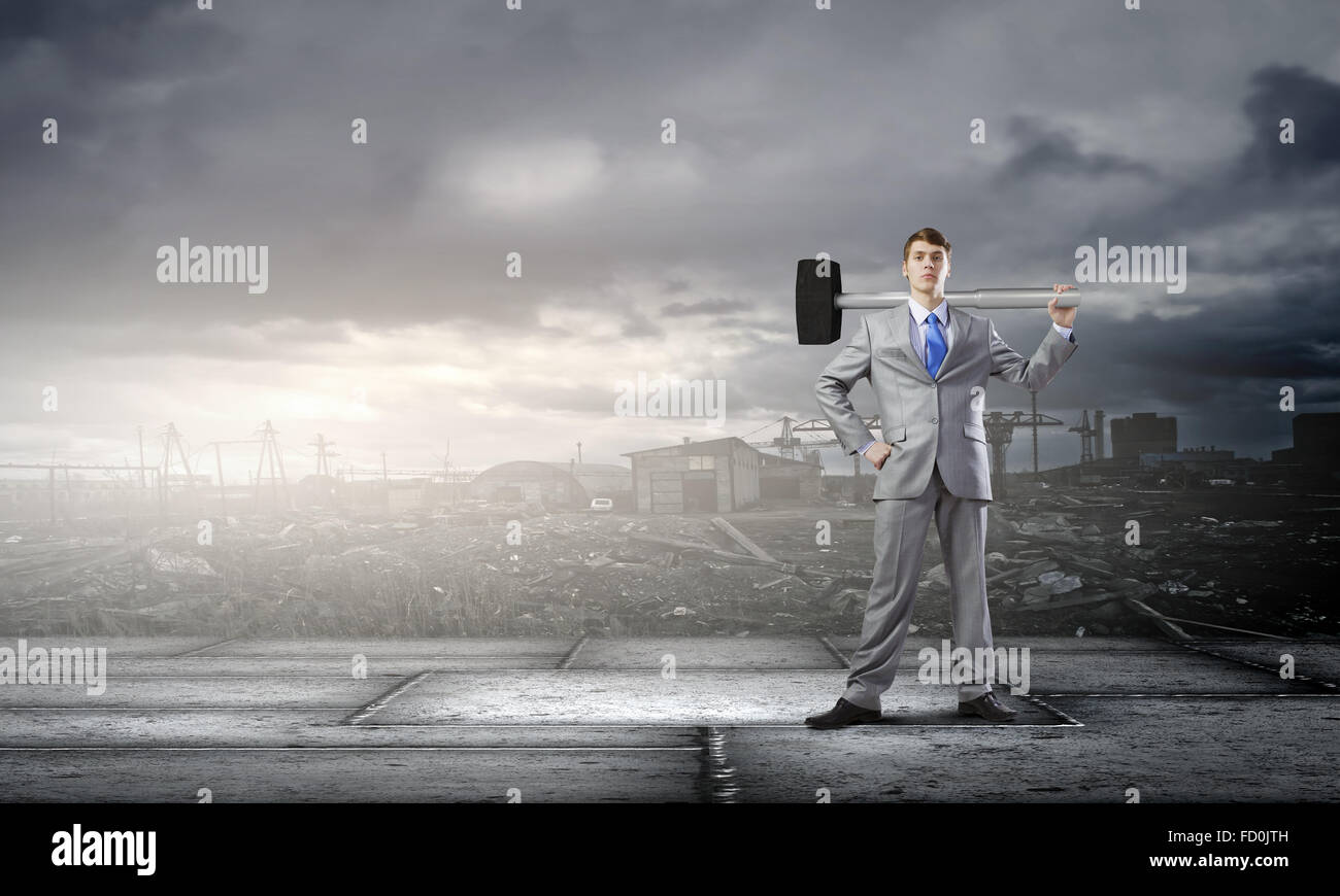 Young determined businessman with big hammer in hands Stock Photo - Alamy