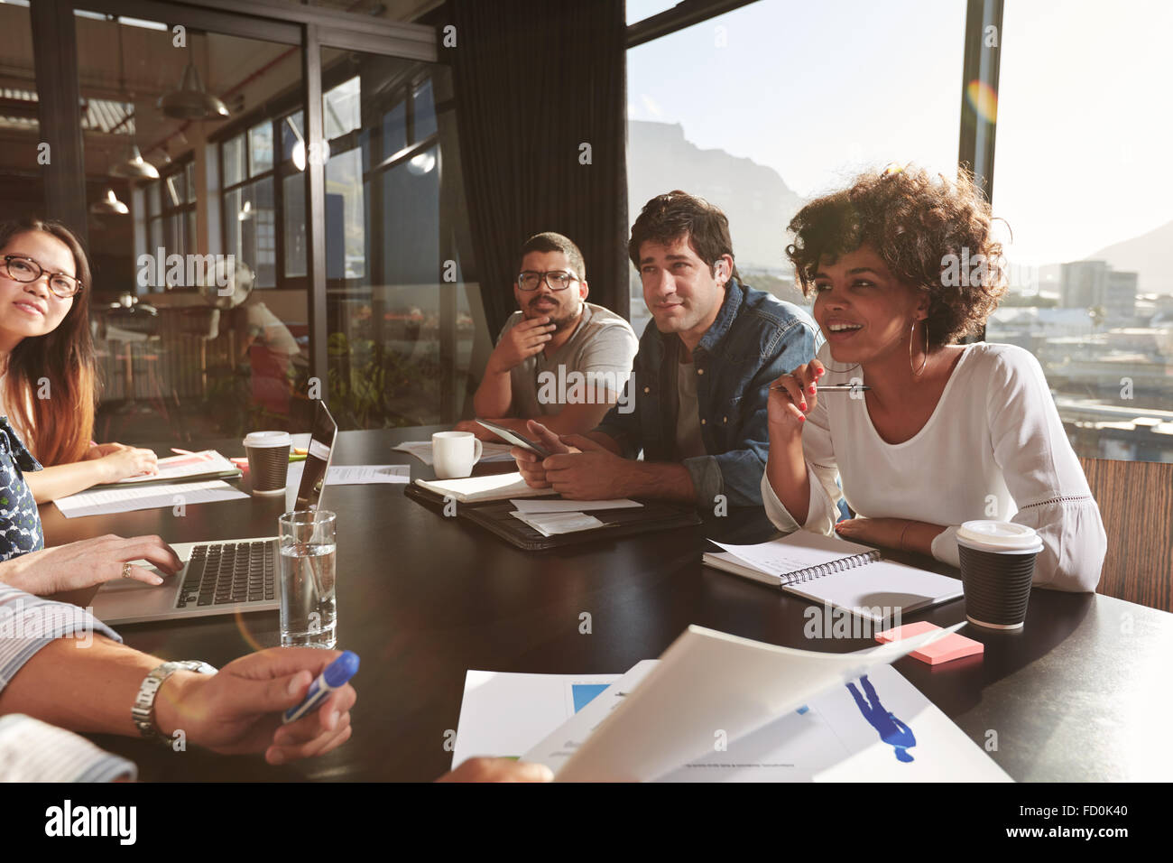 Team of young people discussing new business plan during a meeting in ...