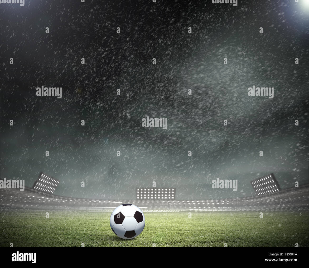 Rain pouring on stadium and soccer ball on grass Stock Photo - Alamy