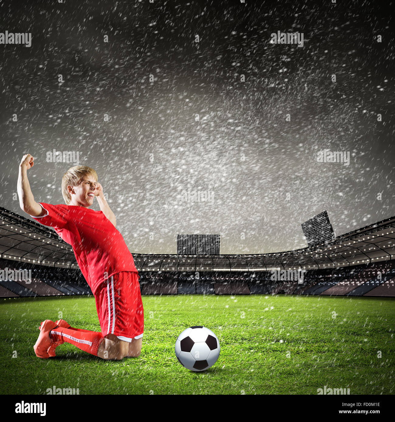 Football player standing on knees and screaming with joy Stock Photo ...