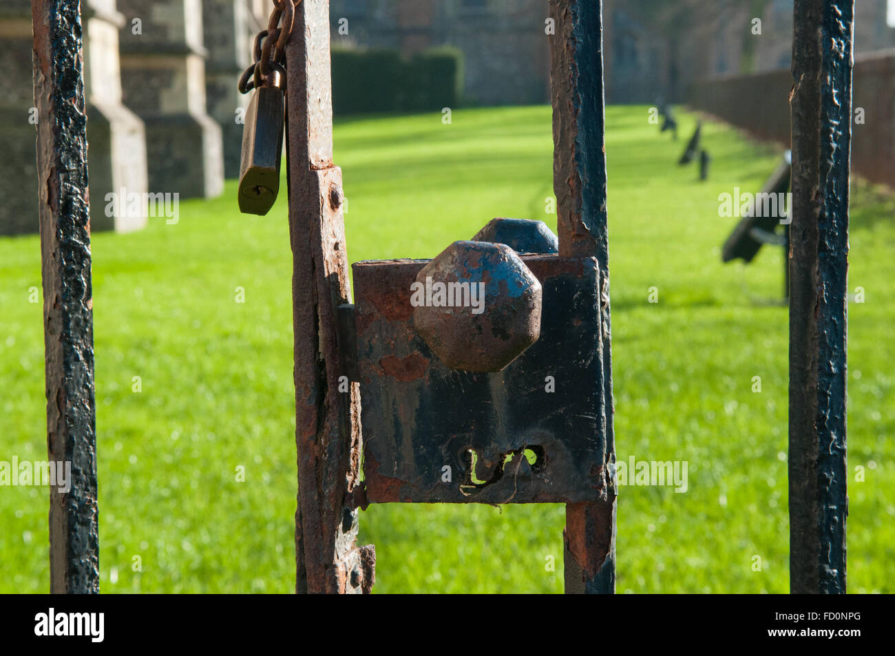Old gate locked with a rusty padlock Stock Photo - Alamy